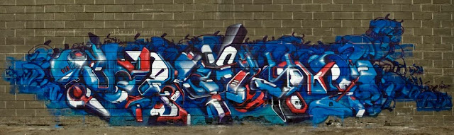 Blue Digital Graffiti Stack Letters in Wall | Digital Graffiti
