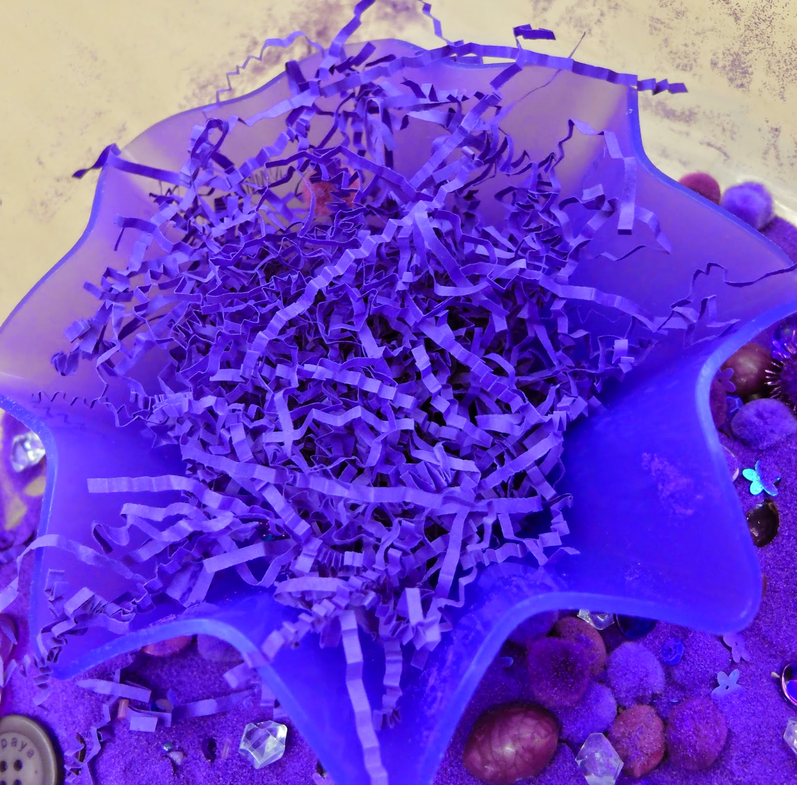 purple sensory bin - rubber boots and elf shoes