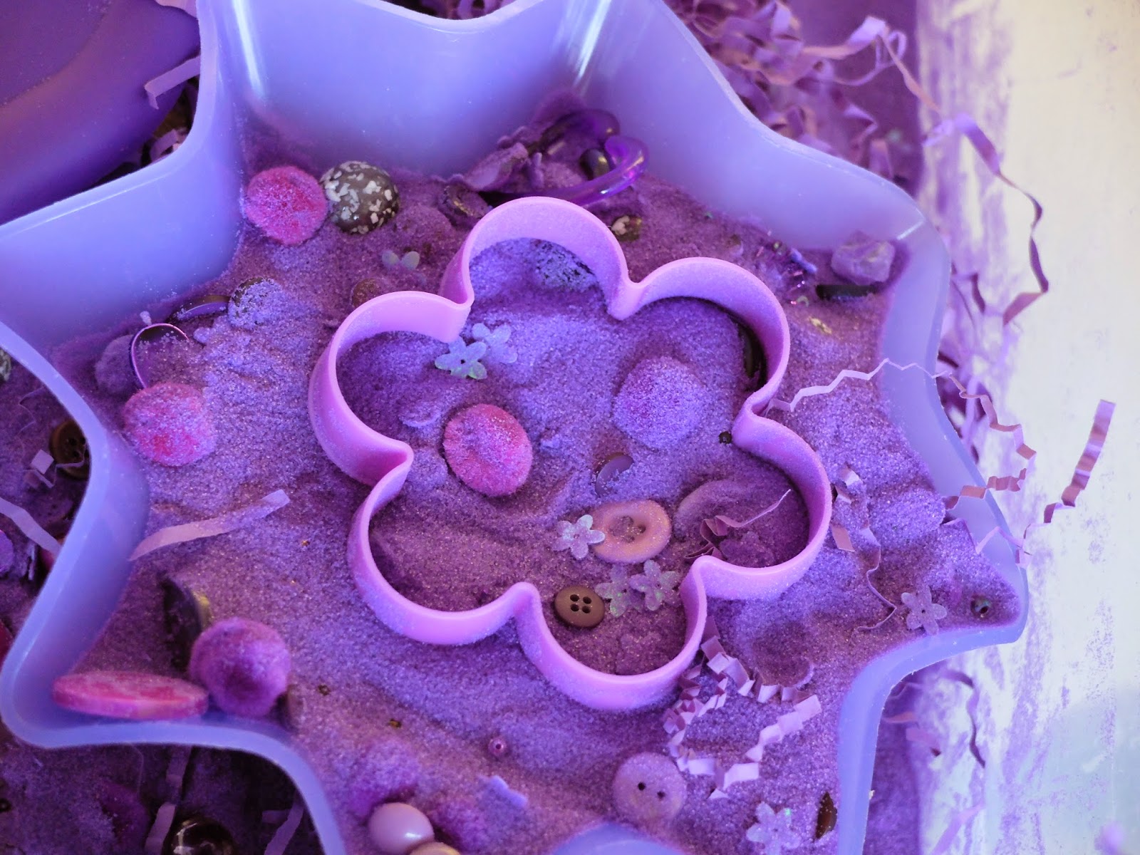purple sensory bin - rubber boots and elf shoes