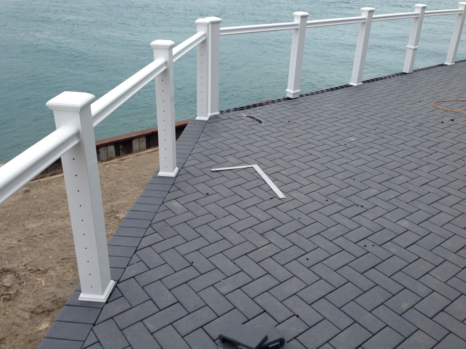 Outdoor Living: Low sloped roof decks, composite pavers and cable rail.