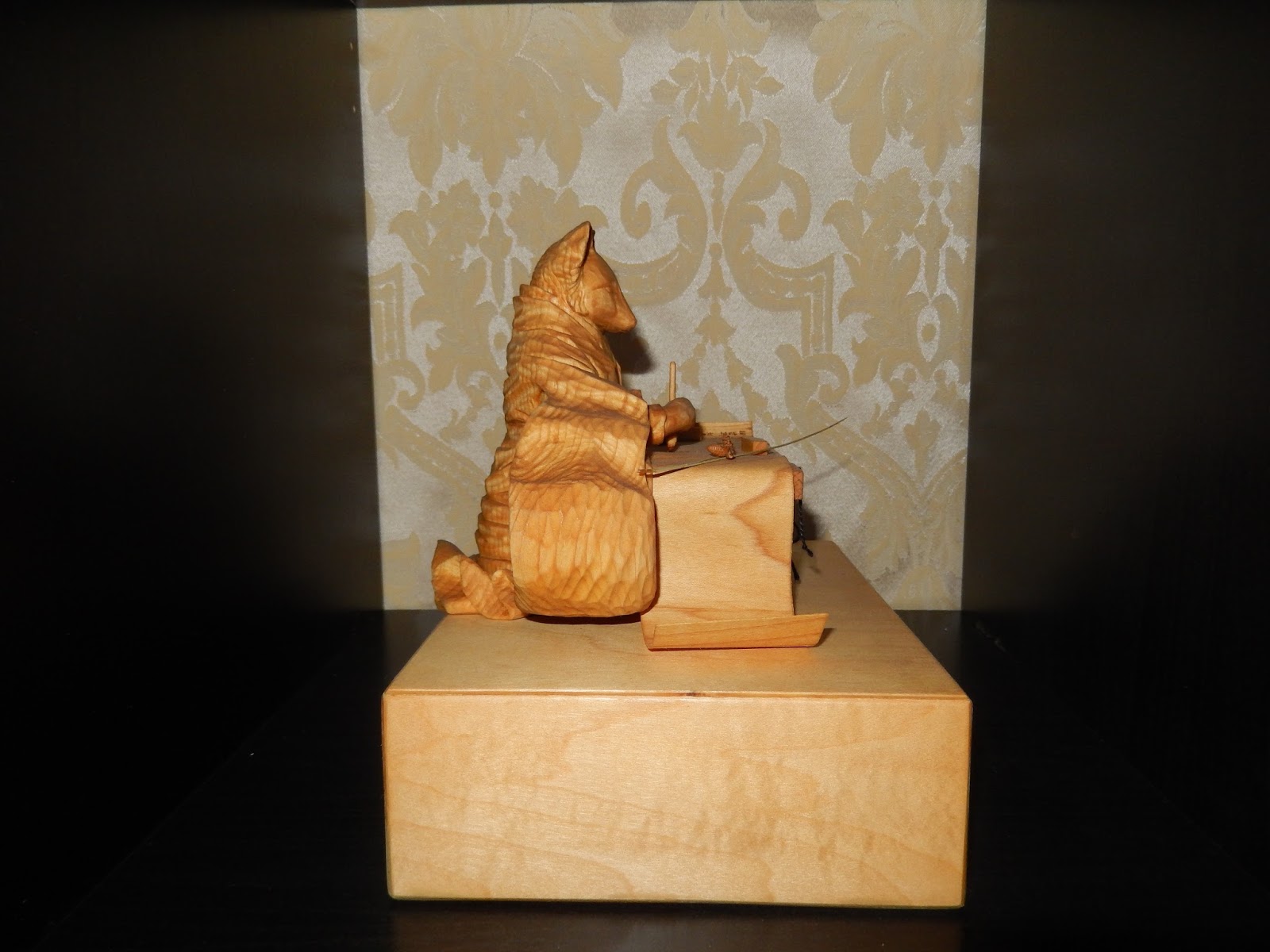 Woodcarving by Hannah Woodward: Fox 1 (The fox practices calligraphy.)