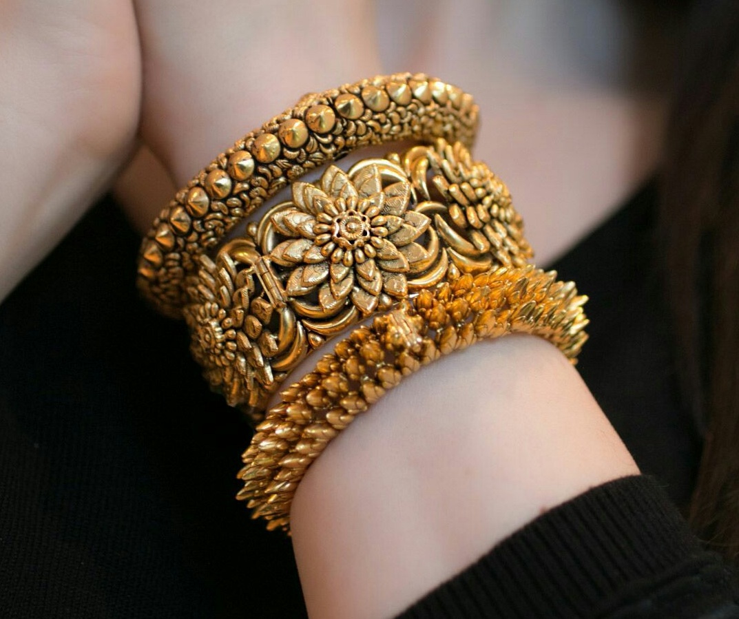 Broad golden bangles