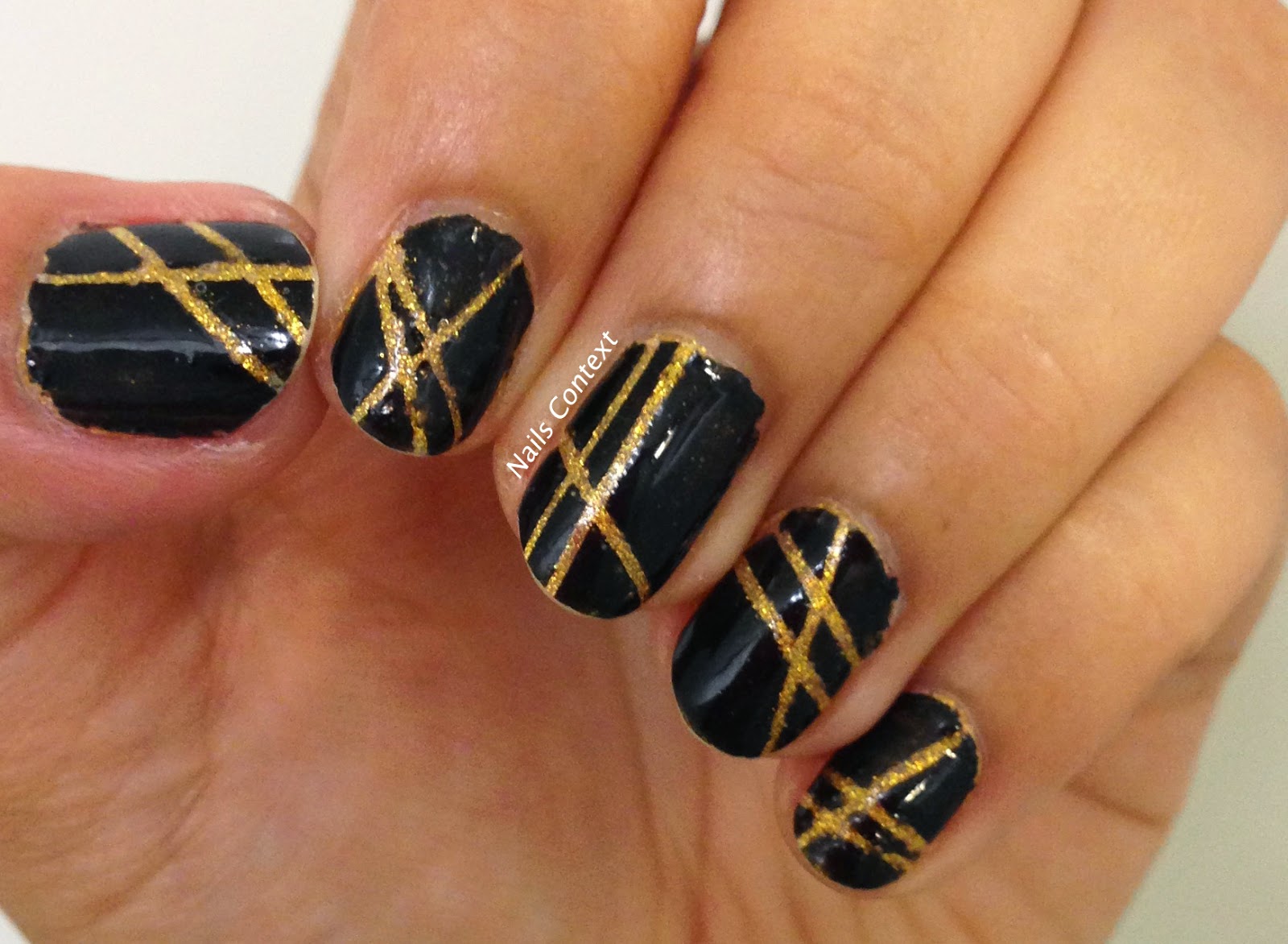 Nails Context: Black n Gold laser tape manicure