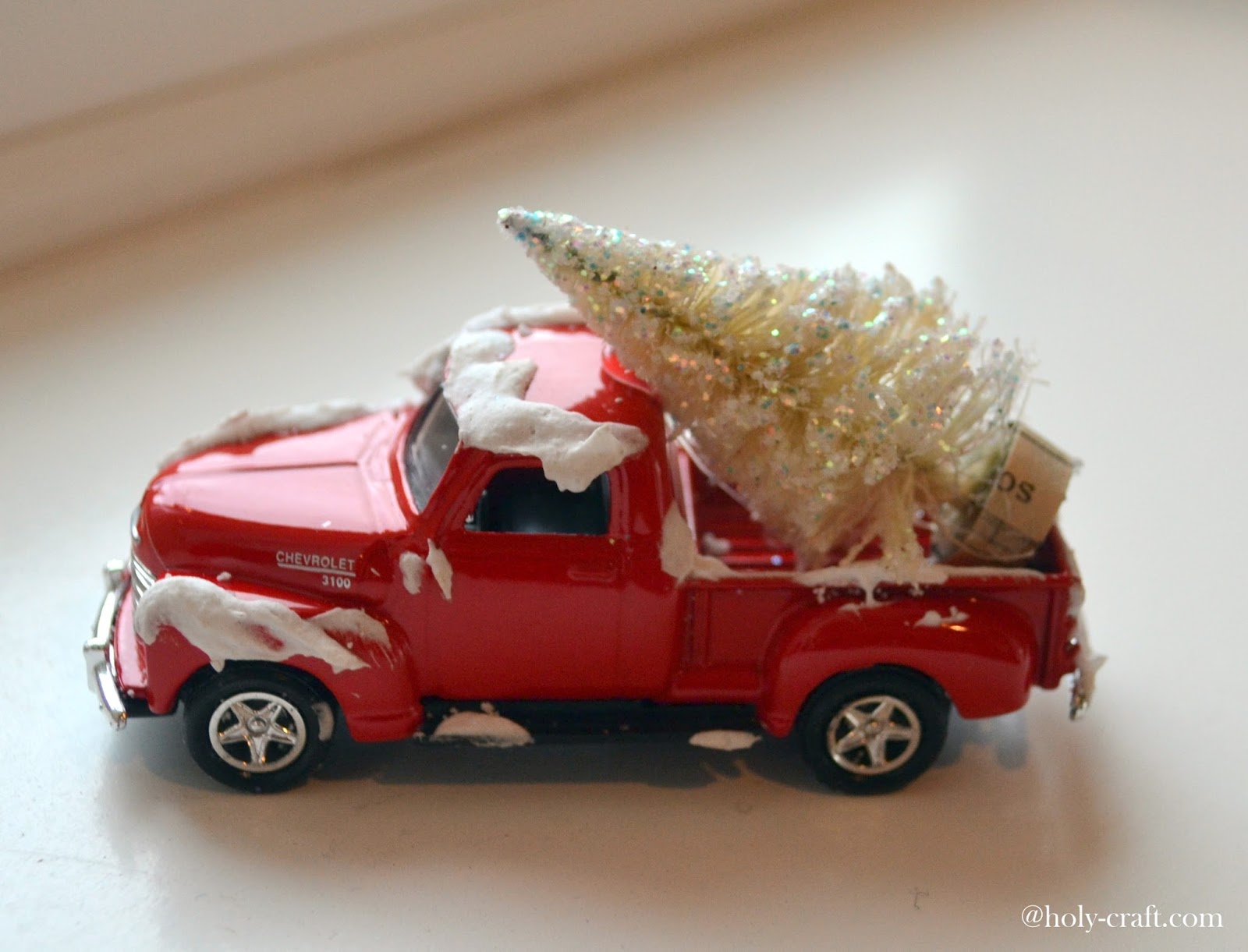 Die cast car with snow and Christmas tree