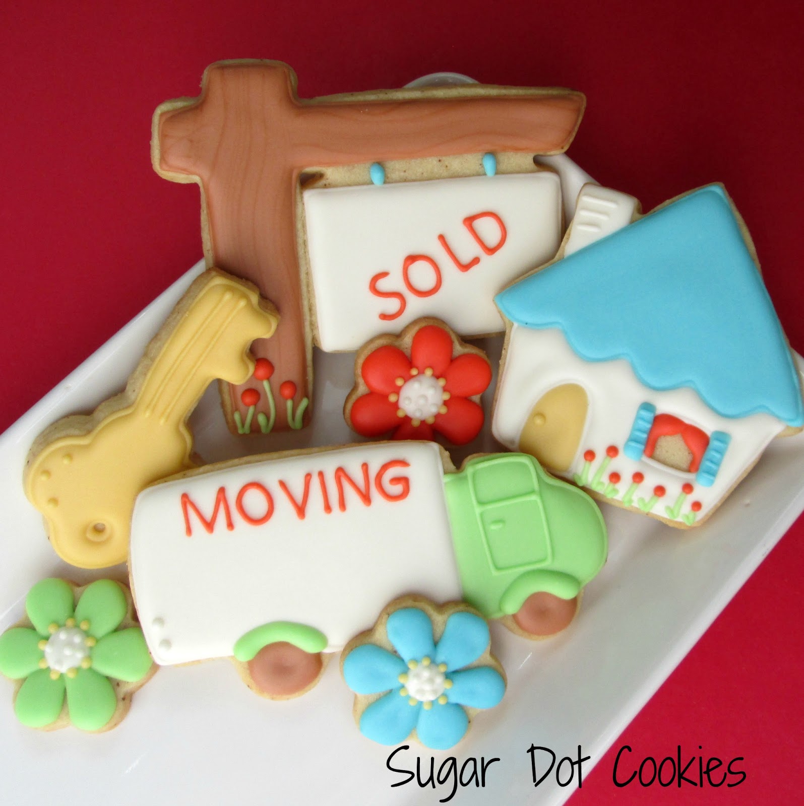 Real estate sold signs, moving vans, keys, houses, and mini flowers.