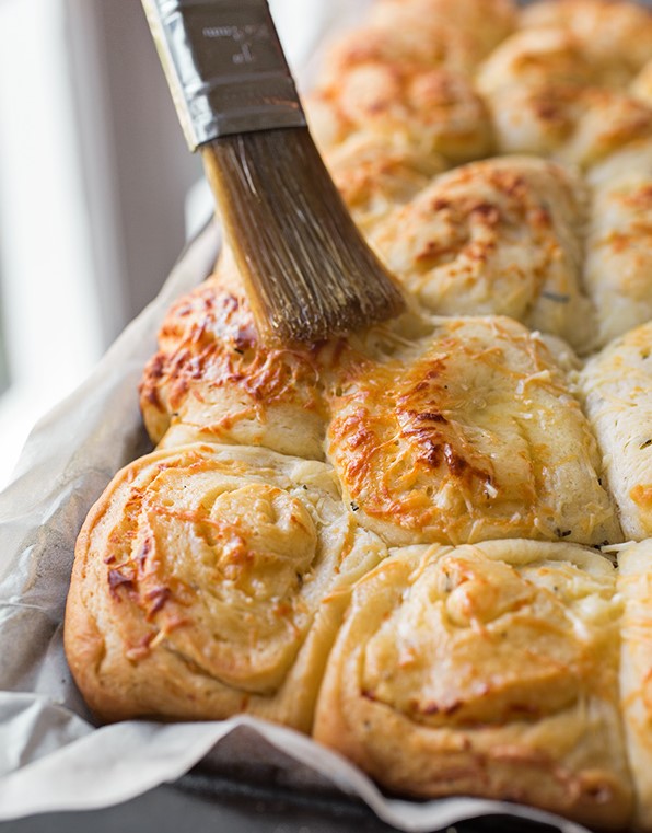 Light and fluffy dinner rolls are infused with fresh rosemary