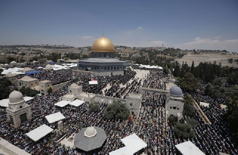 Palestinian Muslim worshipers pray outside the Dome of the Rock