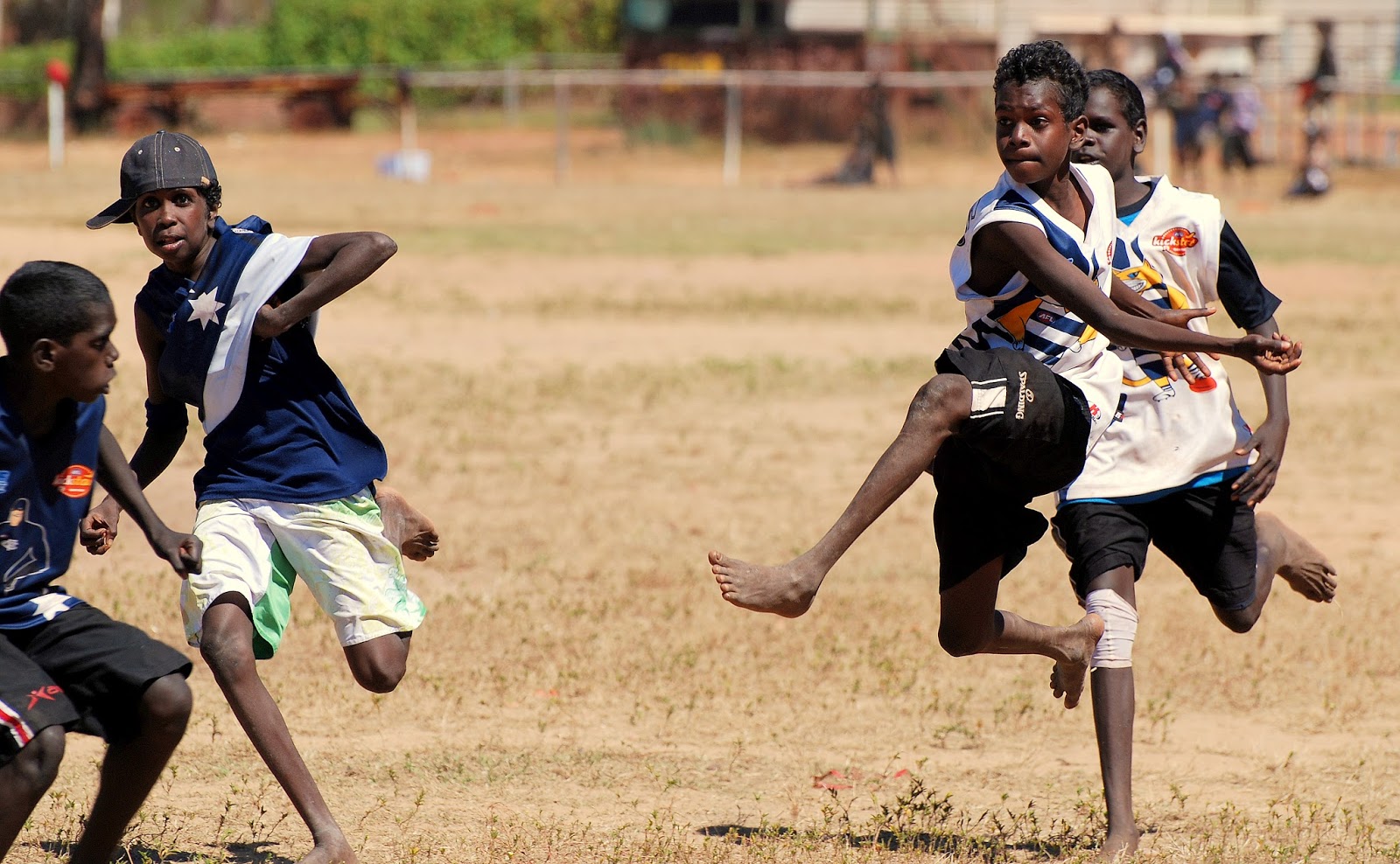 Tofu Photography: An Aboriginal boy energetically kicking the ball ...
