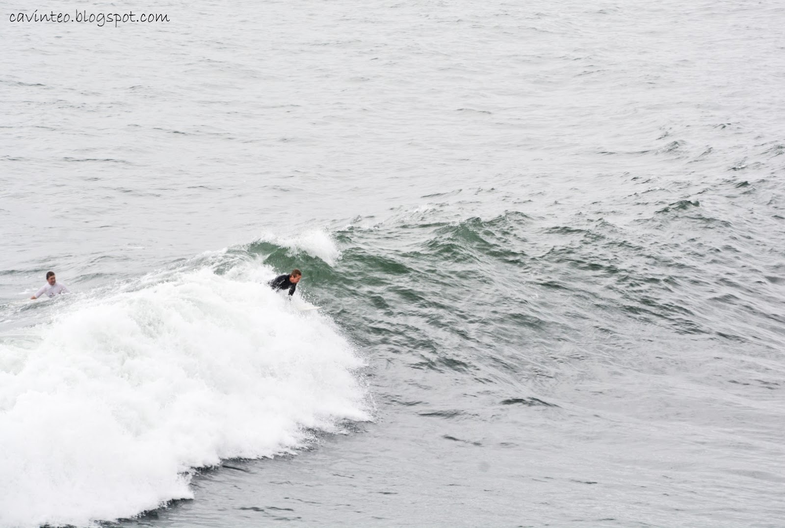 Entree Kibbles: Surfers Surfing on Choppy Waters at Tanah Lot in Bali ...