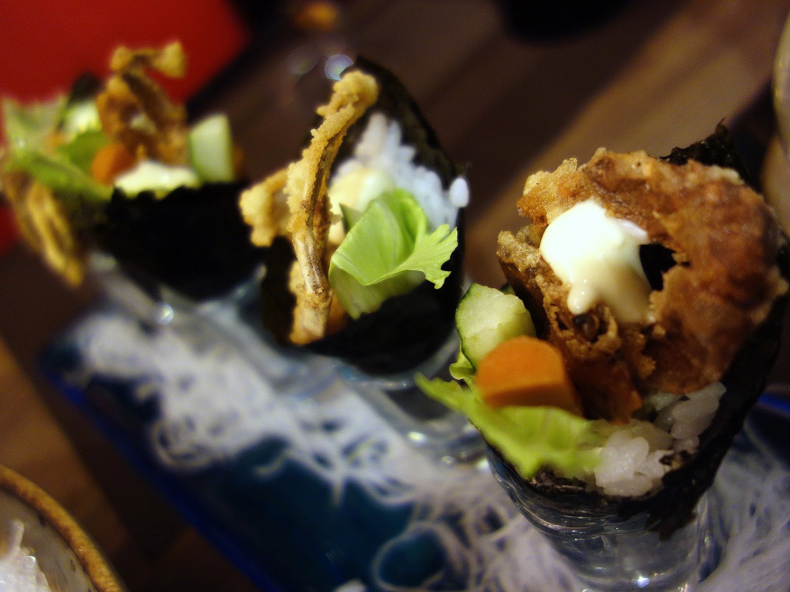 A row of mini soft-shell crab hand rolls, impeccably prepared. Very nice.