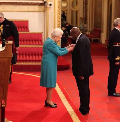 Queen Elizabeth presents MBE to Chukwu-Emeka Chikezie at Buckingham Palace