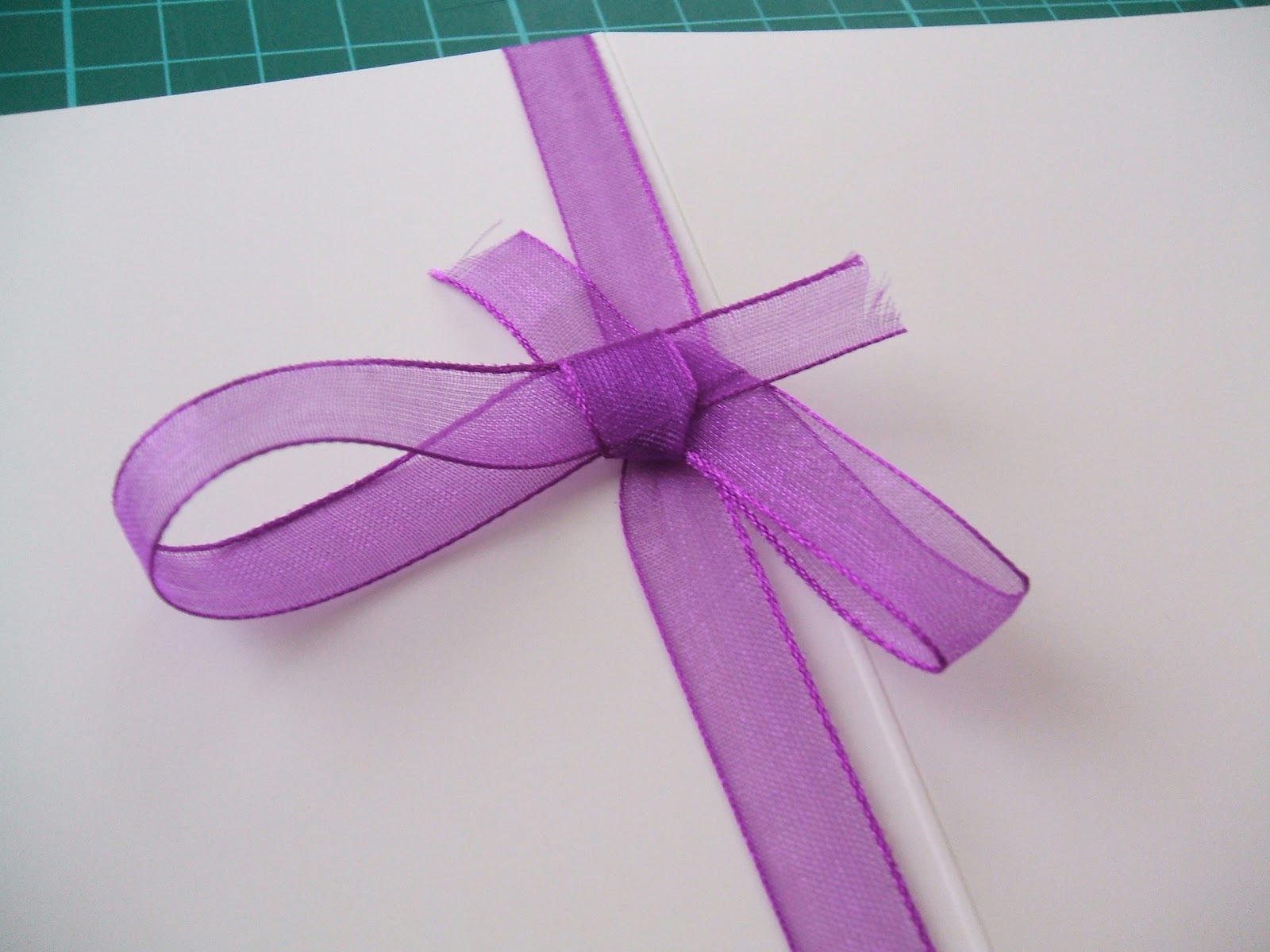 say it says: How to tie a ribbon round a card