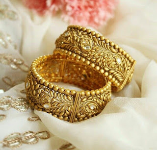 Broad golden bangles