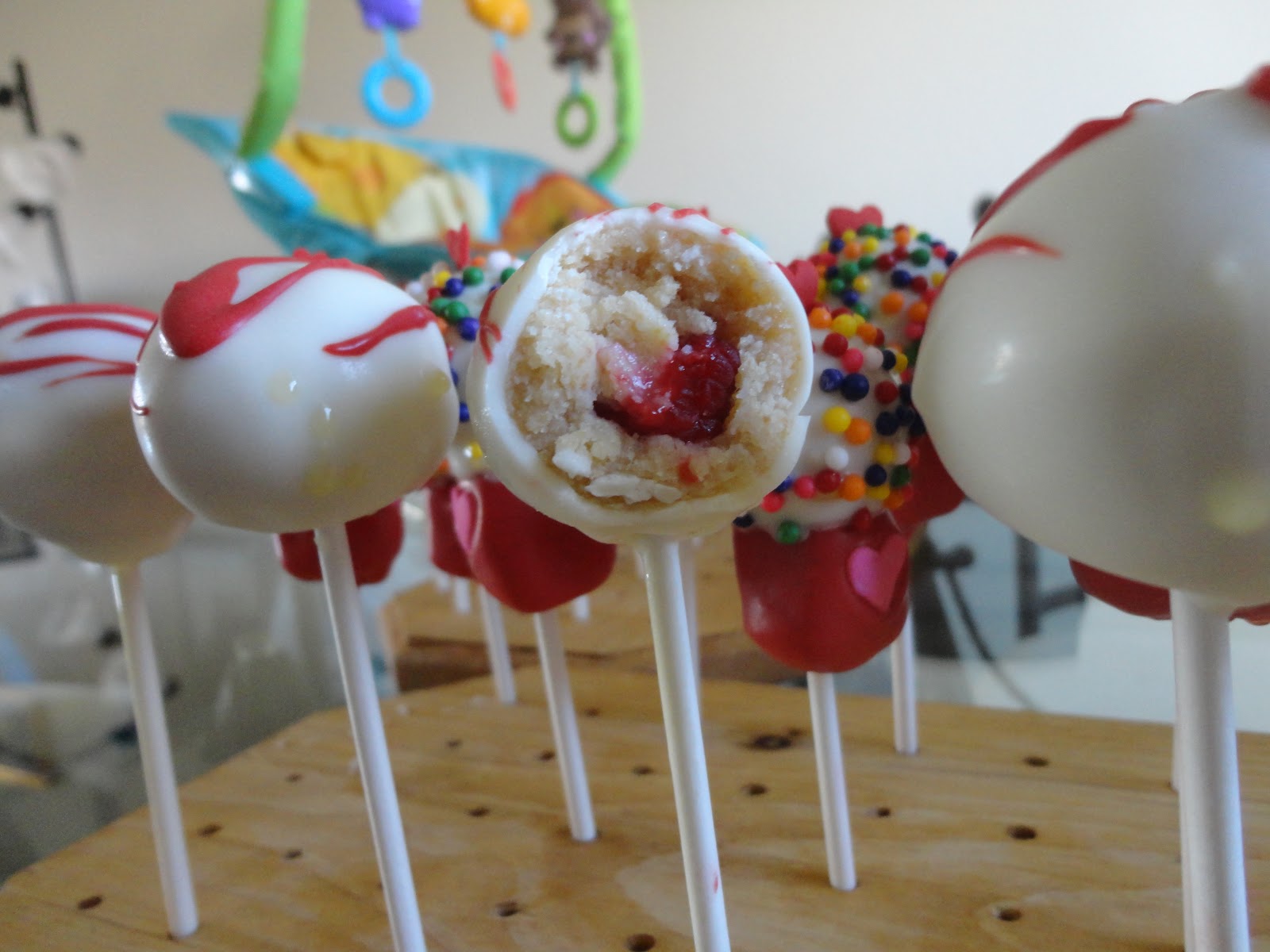 Dipped, Decorated, and Delicious: Raspberry Filled Cake Pops!
