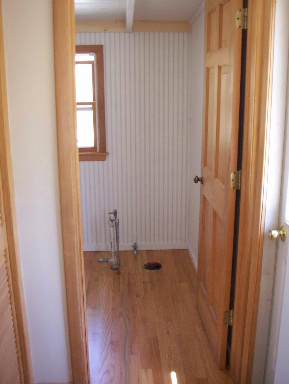 Bathroom with bead board and hardwood floors installed