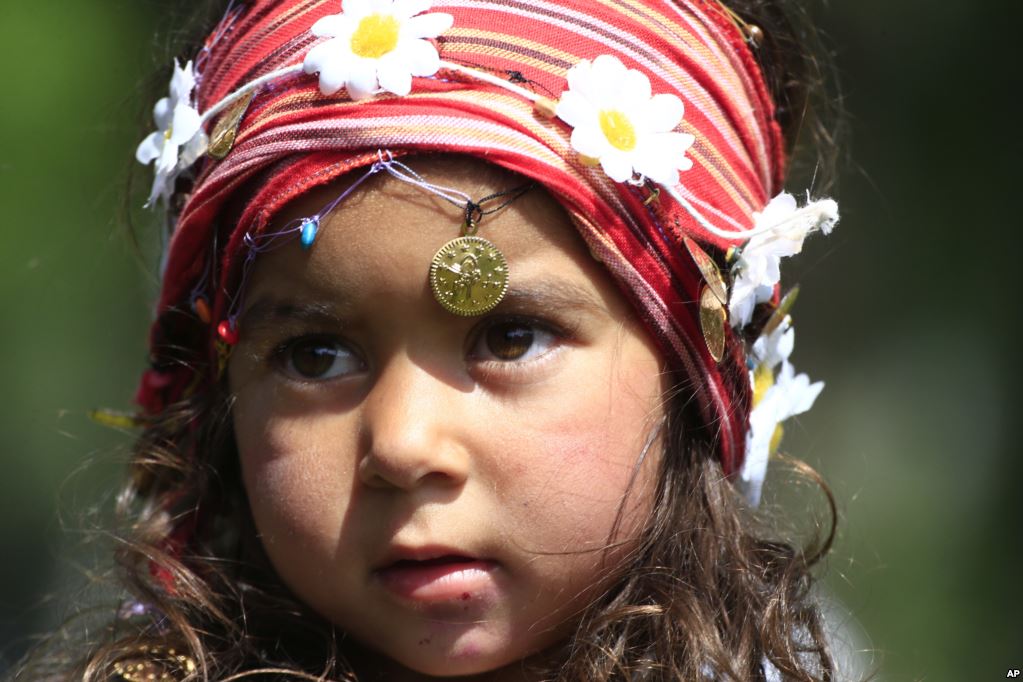A Roma little girl poses for photographers