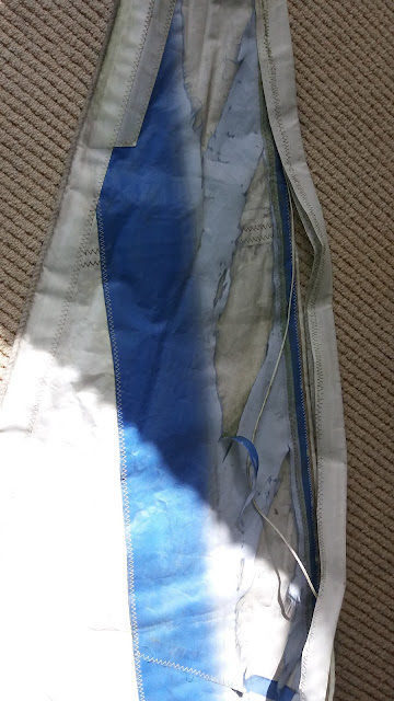 Hank on an old sail worn from years of sliding up and down the forestay ...