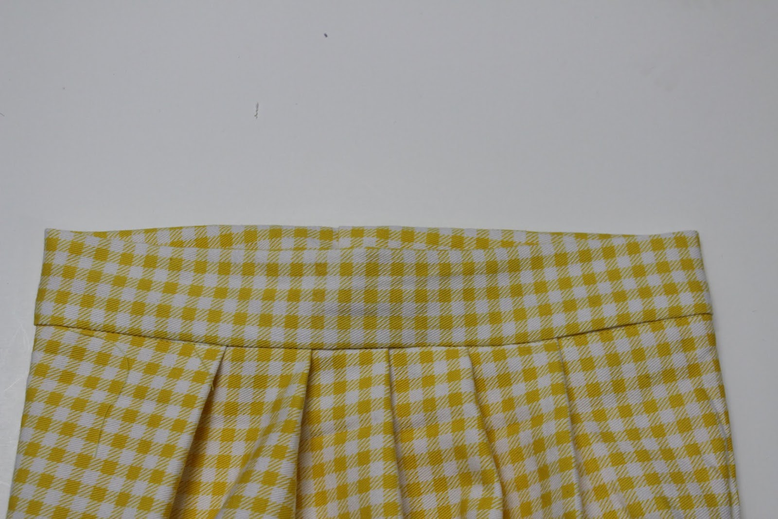 12. Sew a seam right below the waistband, making sure you are catching ...