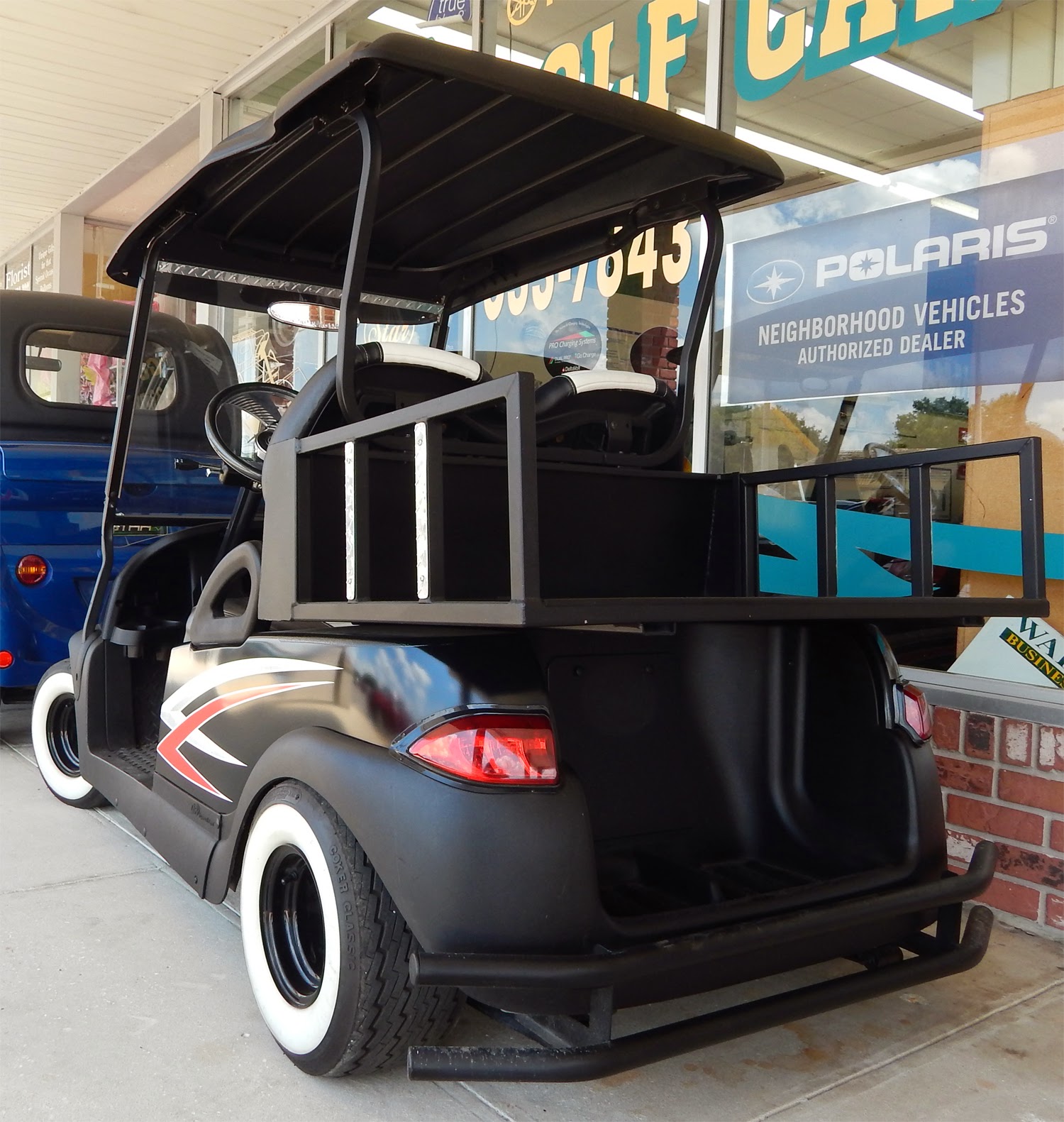 Low Rider scull and cross-bolt Club Car golf cart in Sun City Center Plaza