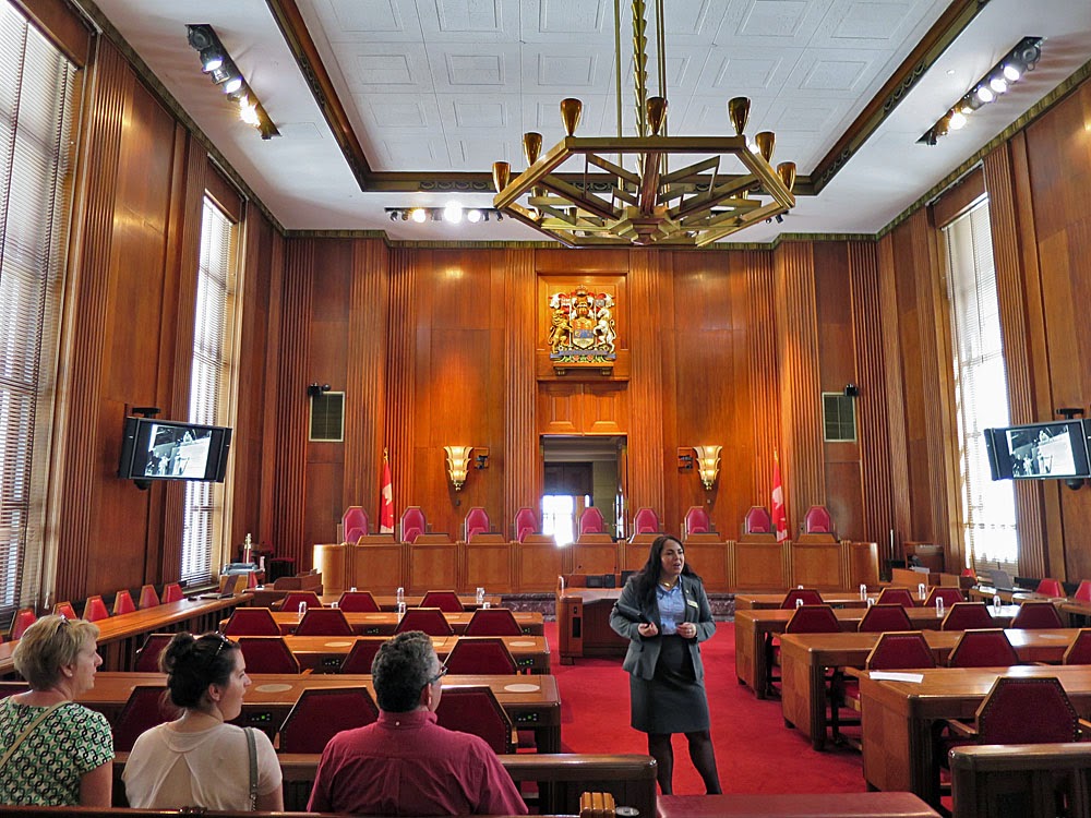 A guide inside the courtroom of the Supreme Court of Canada gives a ...