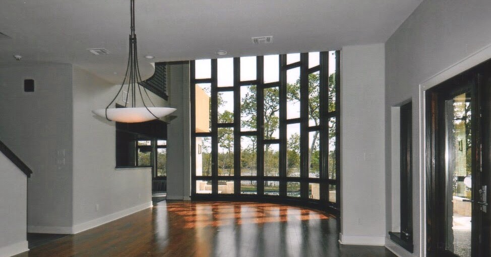 paul light studio: Soaring, curved window wall at custom lakeside home!