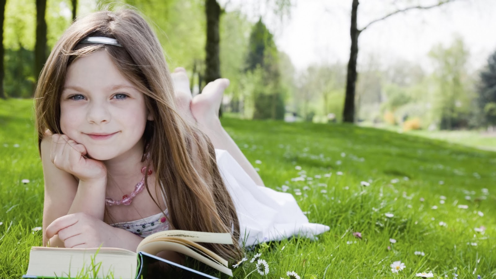 Lovely Little Girl Reading a Book on the Grass - Mystery Wallpaper