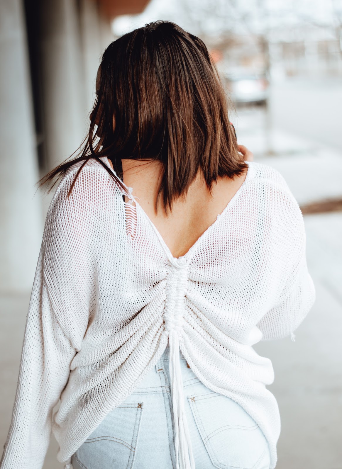 A ripped sweater and denim — I AM CHRISTINA