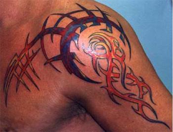Colored Tribal Tattoo On Chest And Shoulder ~ Tribal Tattoo Ideas #59