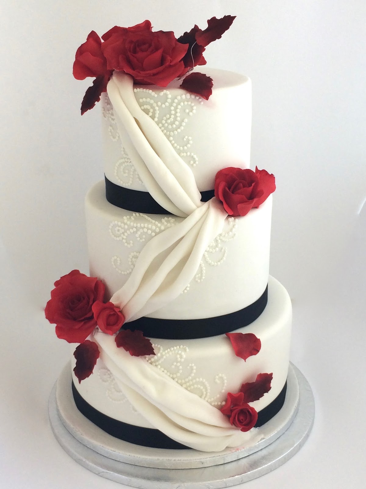 White fondant cake with red Sugar Roses