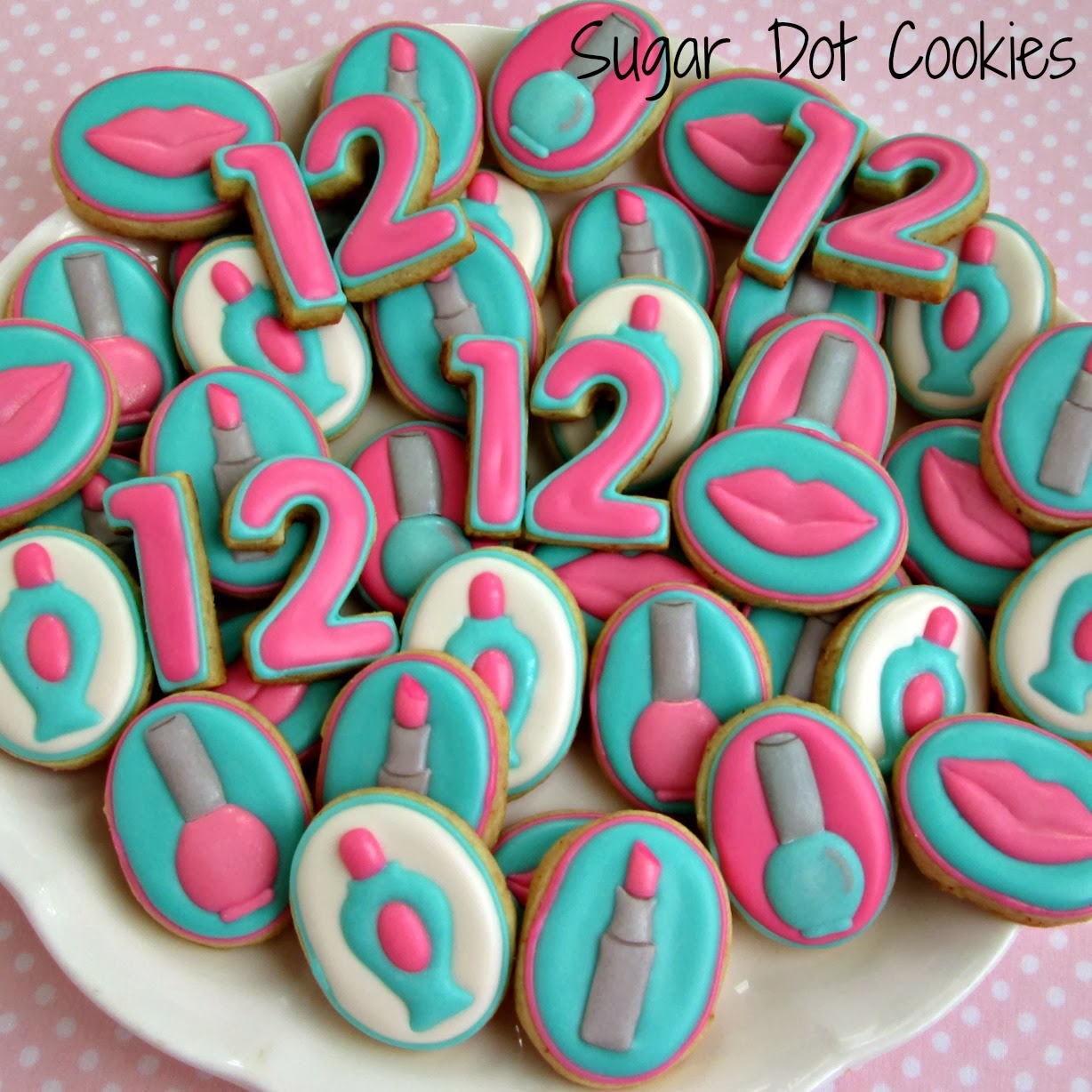 The nail polish, perfume, lipstick and lips were royal icing transfers.