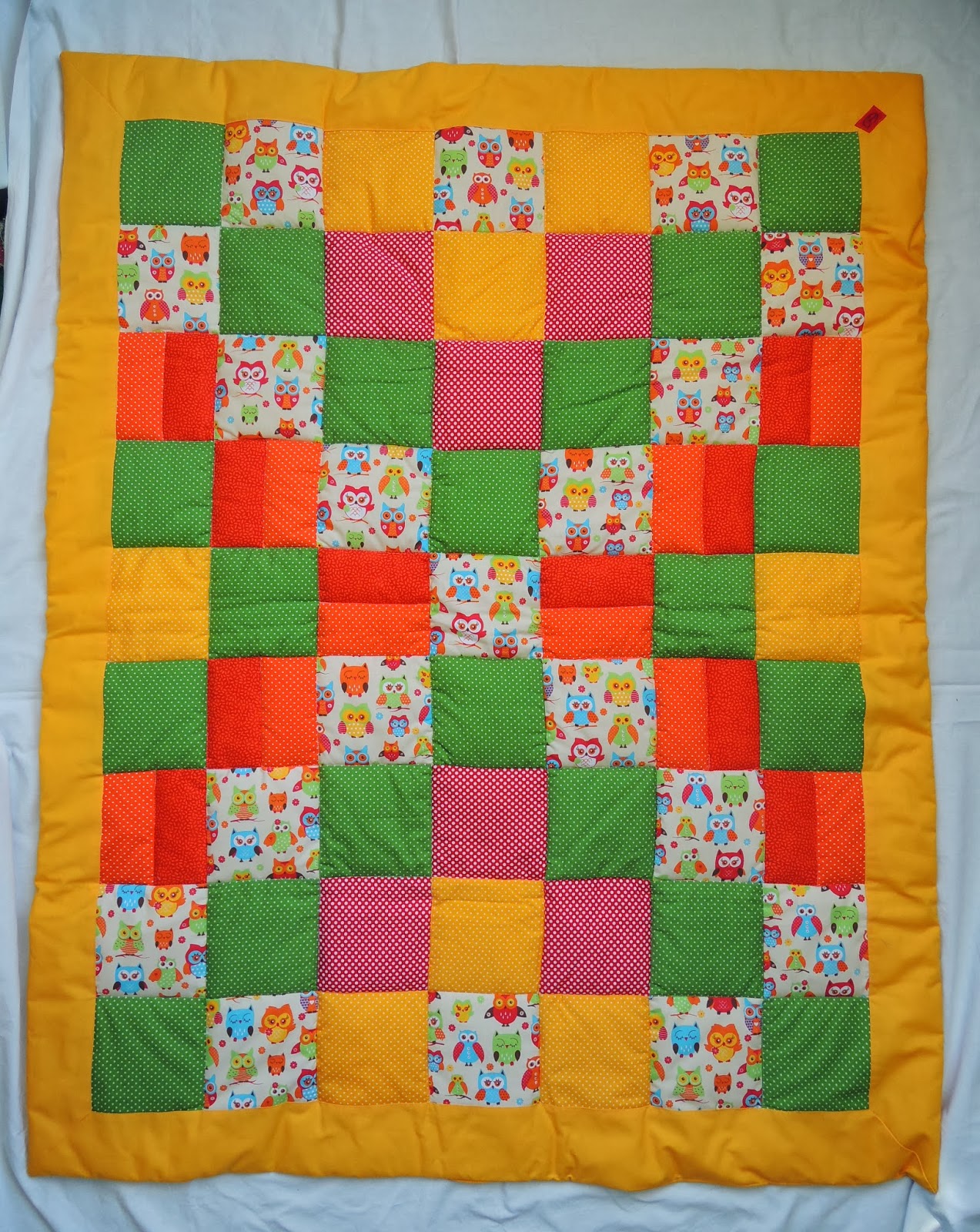 d'Inge: Patchwork-Babydecke Eulen (gelb)