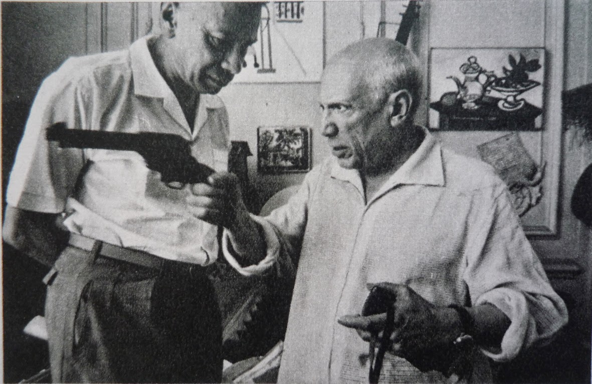 Pablo Picasso wearing a hat and holding a revolver & holster given to ...