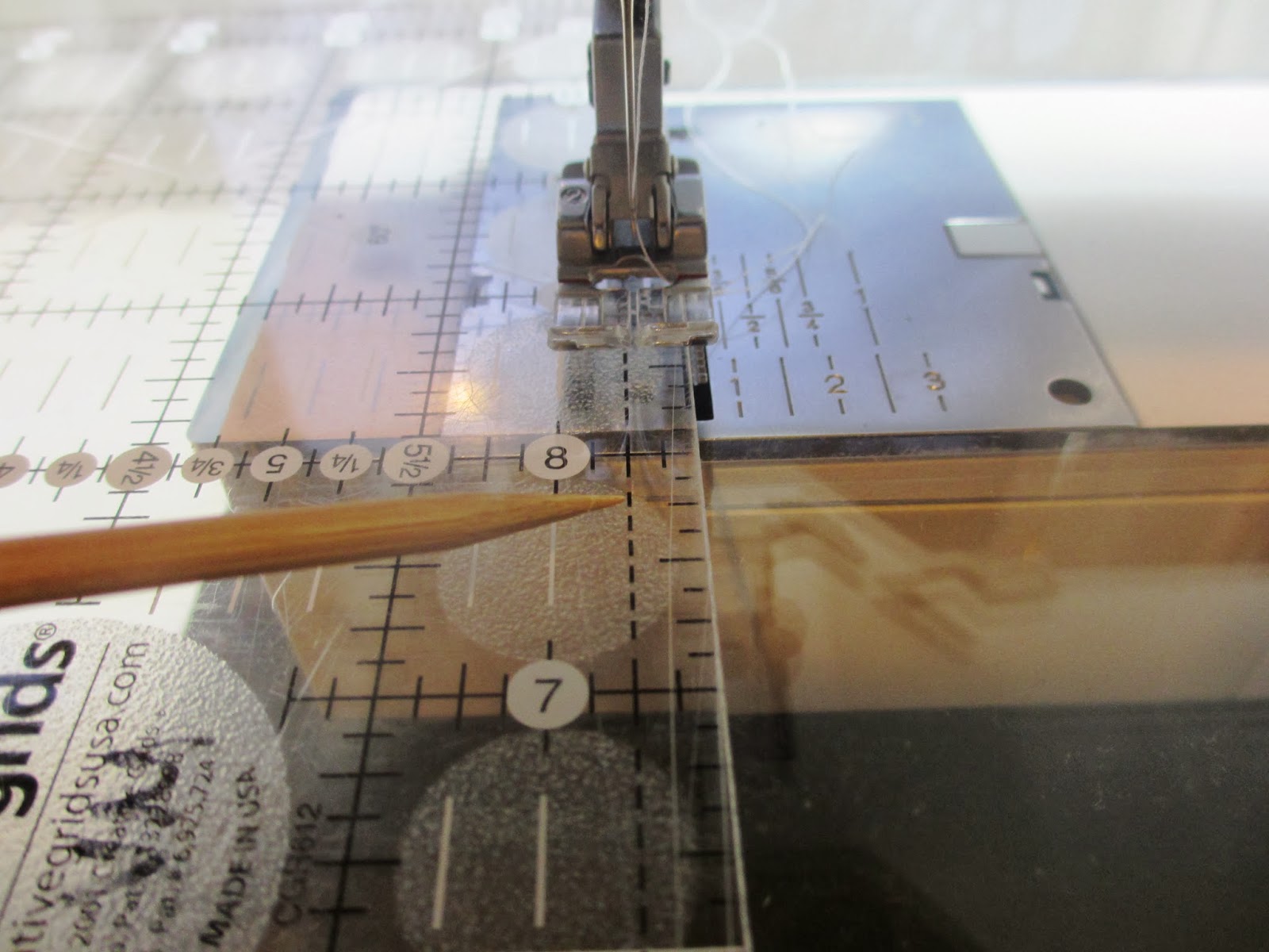 2. Slide the ruler under the presser-foot and lower the needle right on ...