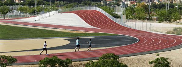 An extra section of track curves up over an artificial hill with the ...