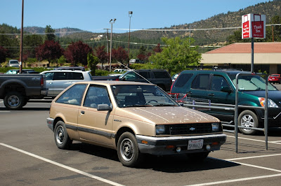 OLD PARKED CARS.: 1986 Chevrolet Spectrum 2-door hatchback.