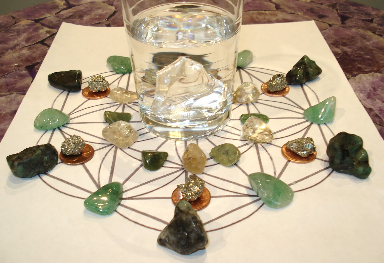 Juice glass with quartz "flame" center stone in an "abundance" grid.