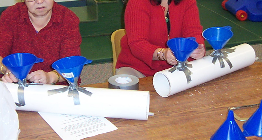 SAND AND WATER TABLES: LARGE PLASTIC TUBE WITH FUNNELS