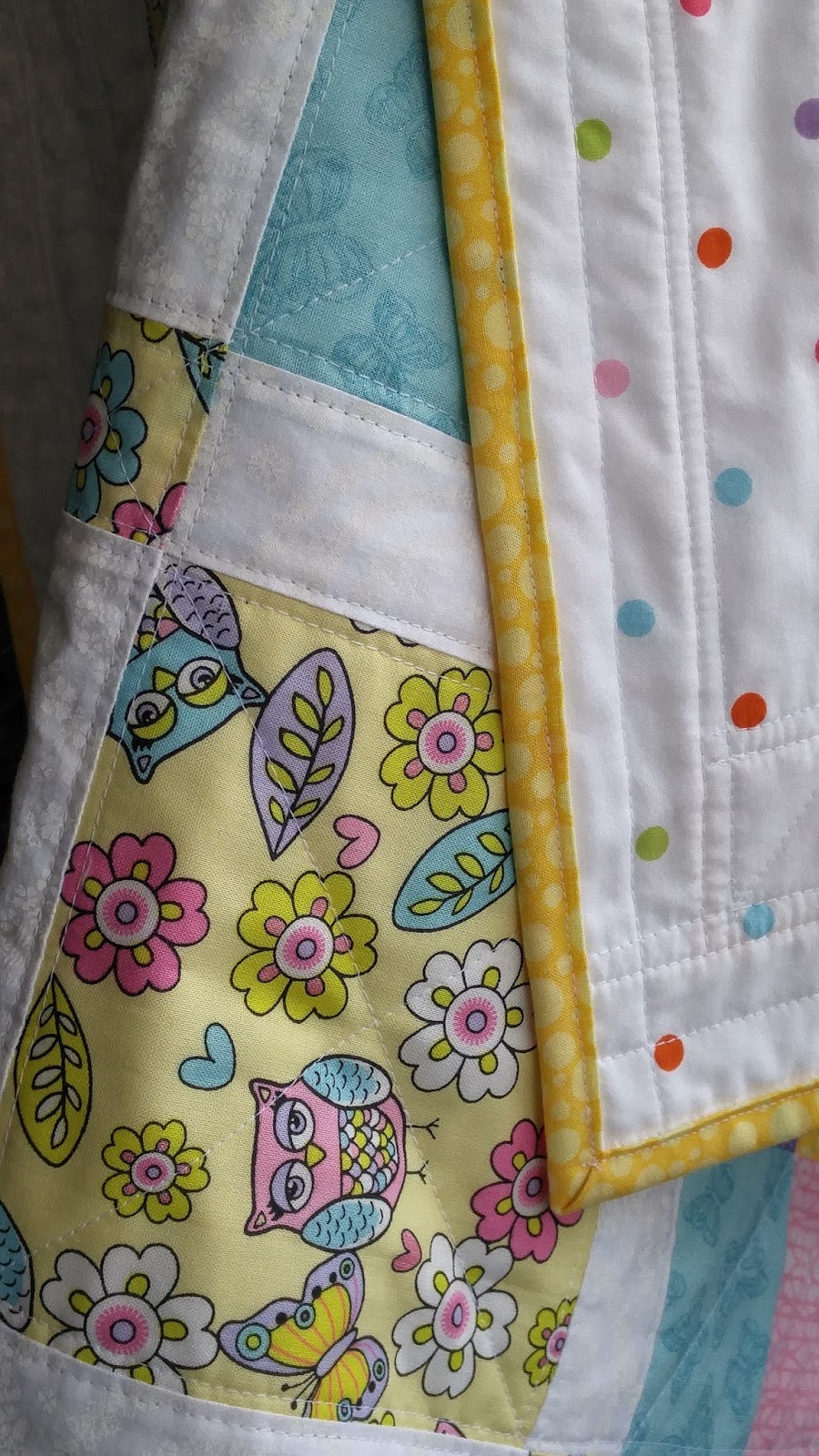 ...by CJ: Bright baby quilt finish