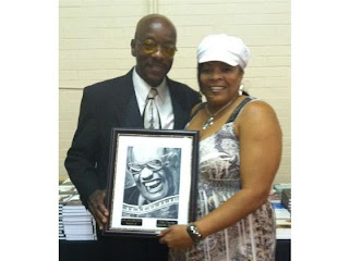 Local artist presents portrait of Ray Charles to singer's daughter