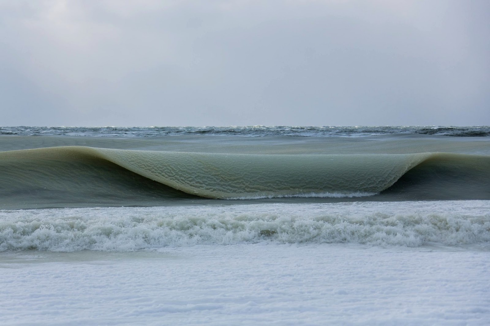 Giant Freezing Waves Infused with Ice Slowly Roll in off the Coast of ...