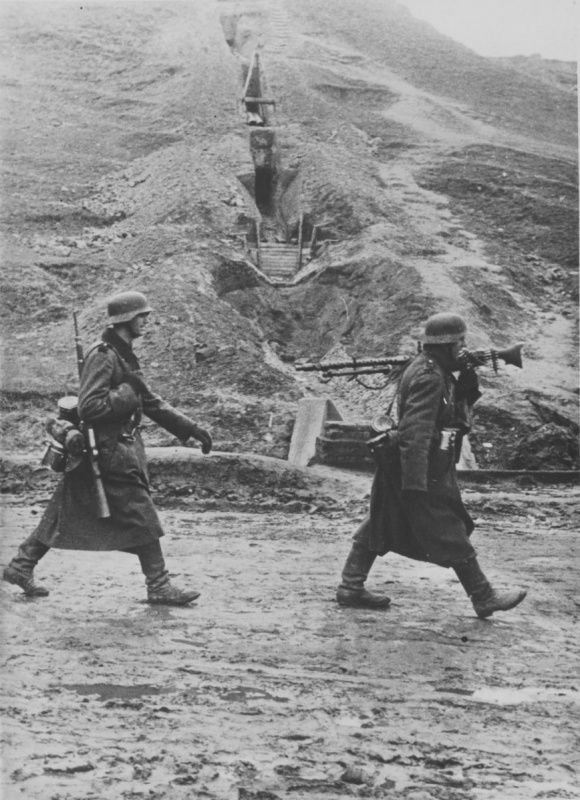 World War II History: Two German soldiers on the road over a hill on ...