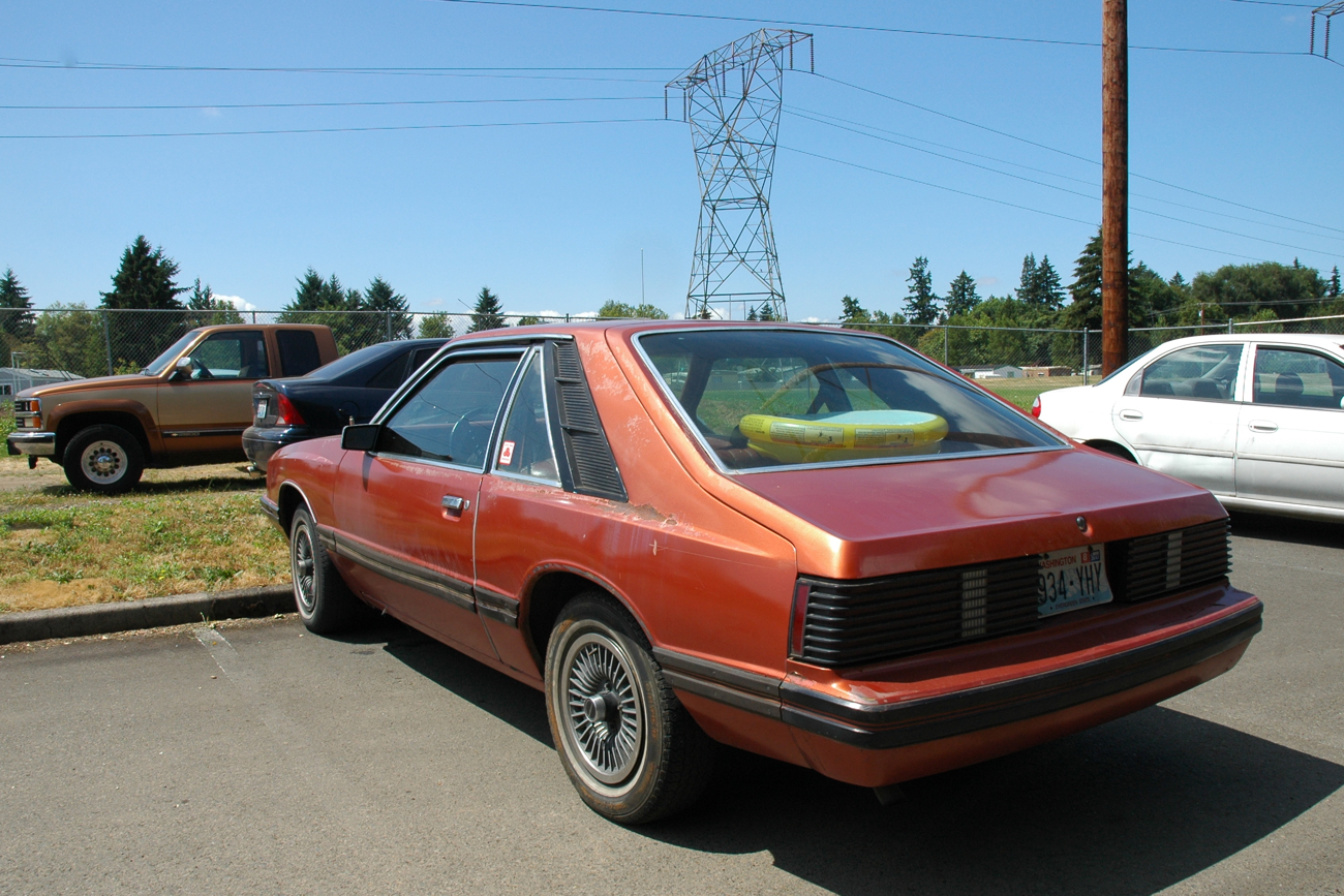 OLD PARKED CARS.: 1980 Mercury Capri.