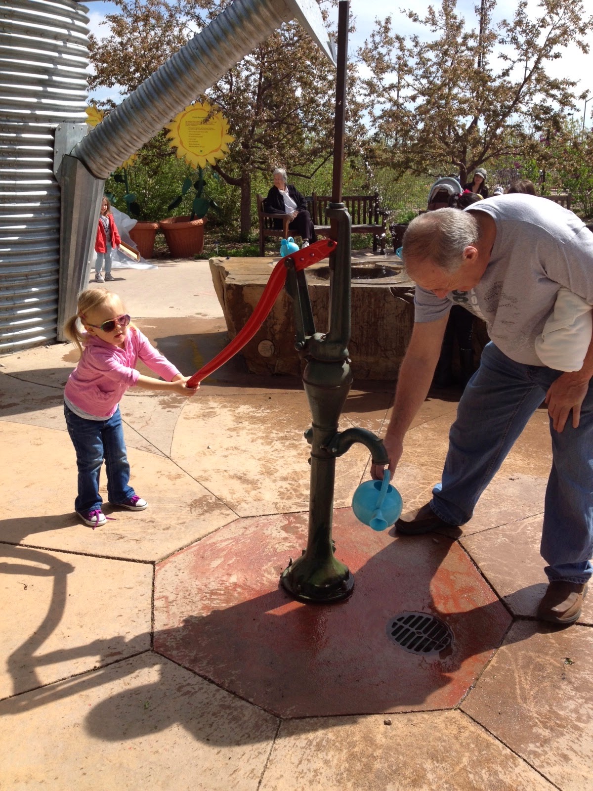 Berken Family: Grandpa and Finn pumping water