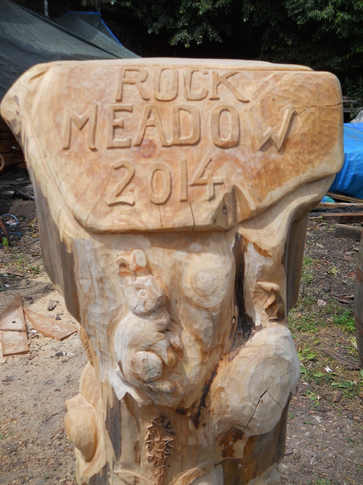 A carved cedar log as a sign for Rock Meadow, a new housing development ...