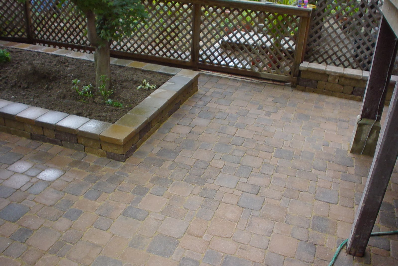 Custom Stoneworks & Design Inc.: Tumbled style pavers with landscape wall