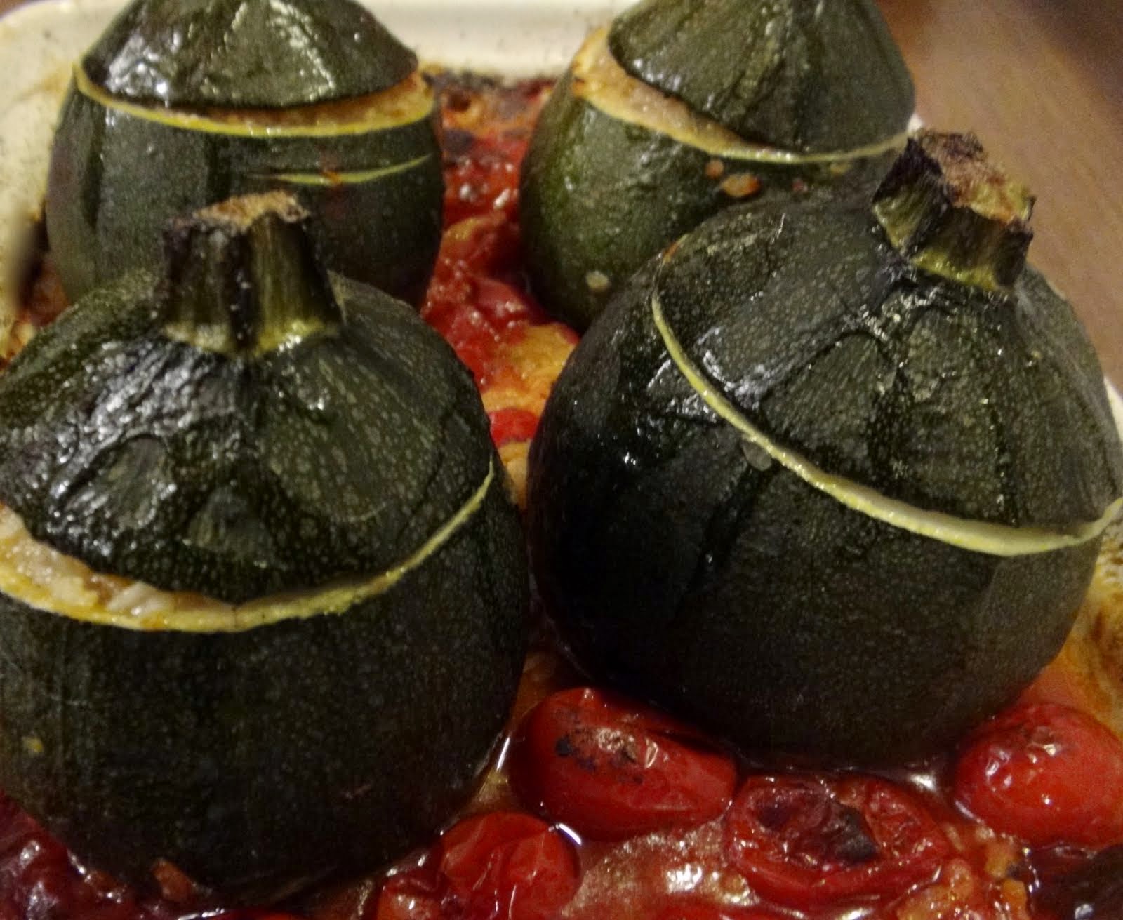 Rice stuffed round zucchini (courgettes) with cherry tomatoes and basil