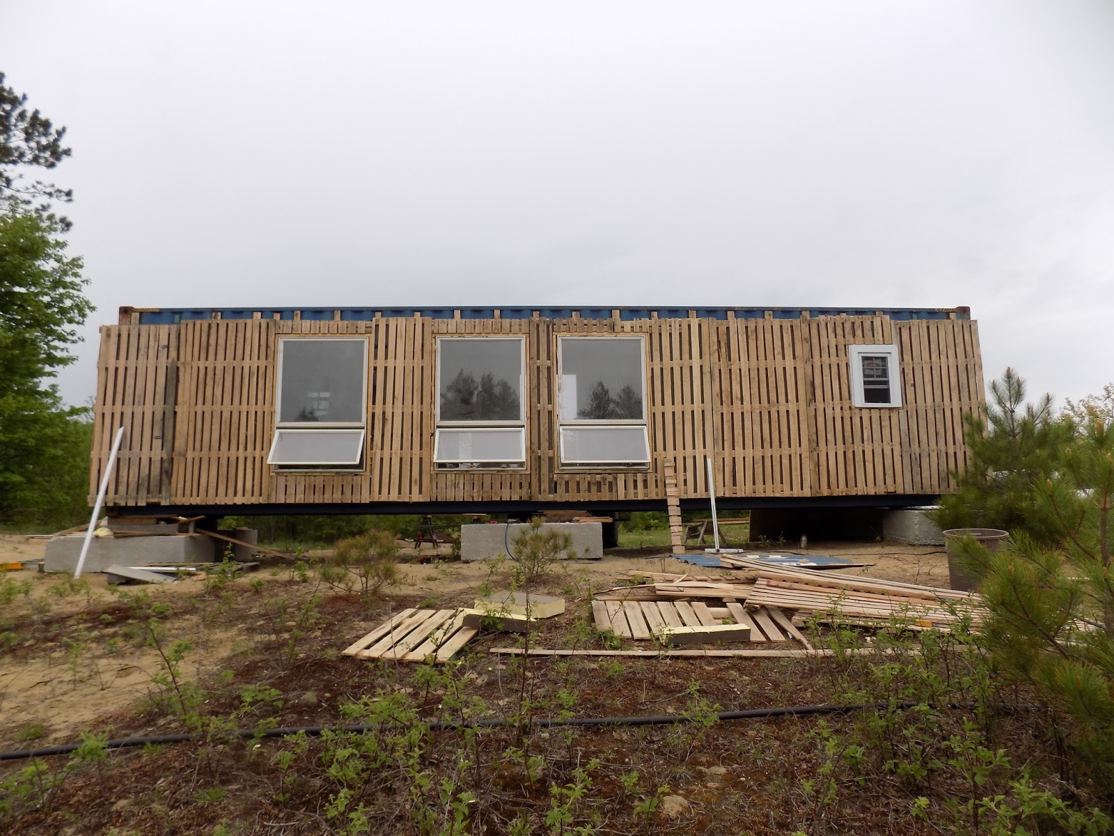 Intermodal House: Strapping on, Windows in, Insulation, Siding Mostly on