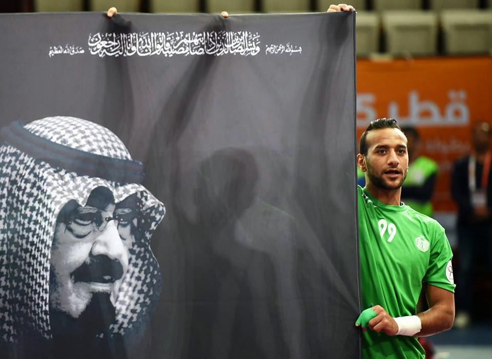 Abbas al-Saffar holds a banner in honor of late King Abdullah