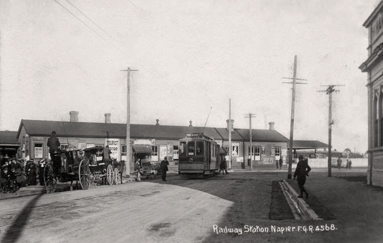 transpress nz: Napier railway station and a tram, circa 1920