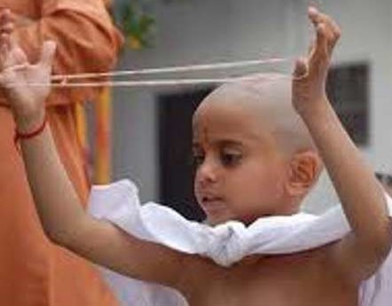 Why do Brahmins wear a white thread (Janaeu) around their body?